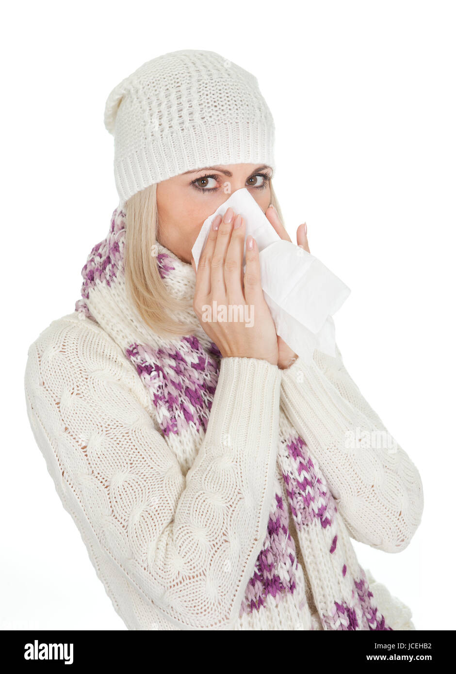 Woman in warm winter clothing sneezing from cold. Isolated on white ...
