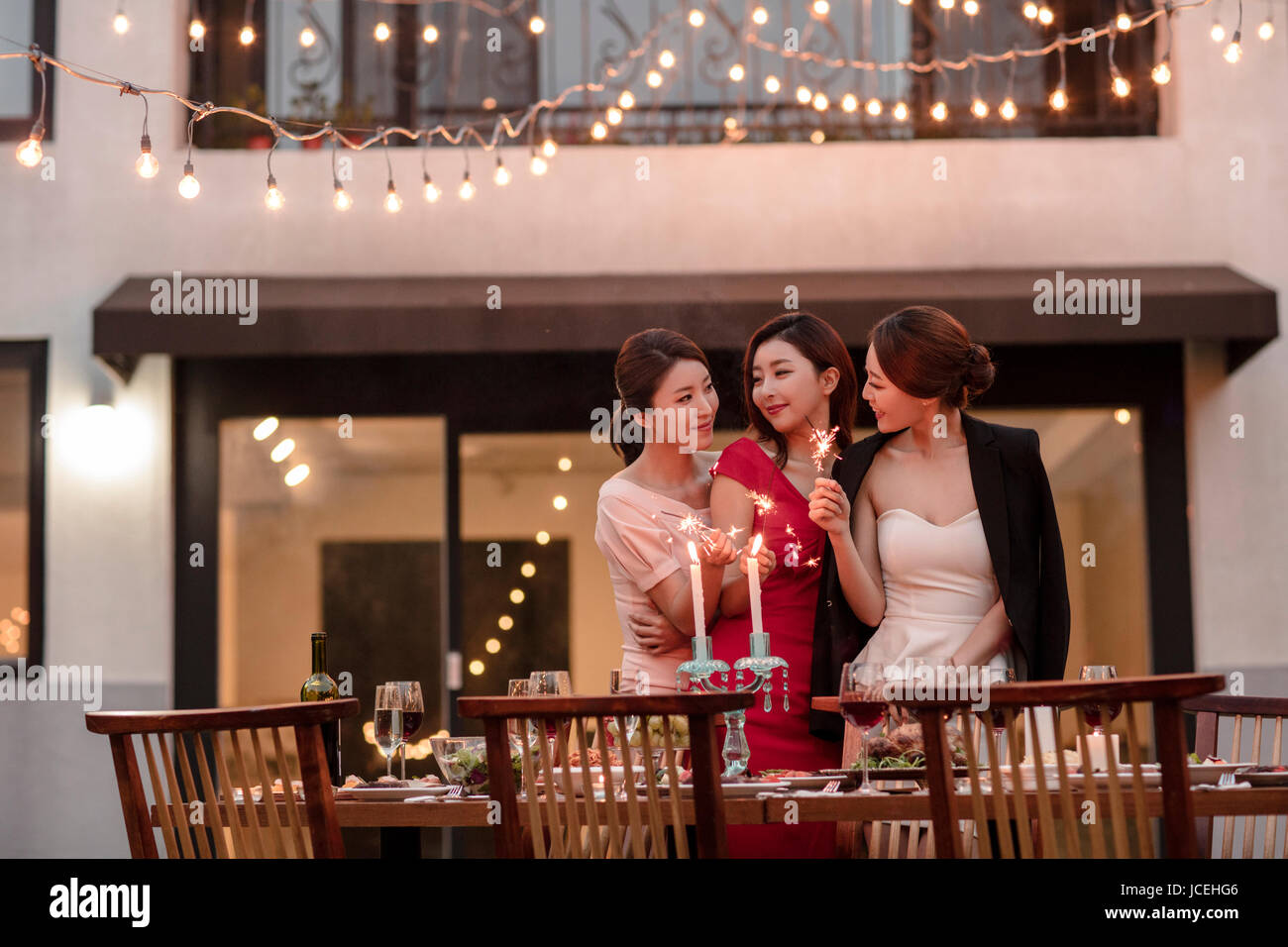 Three young smiling women at party Stock Photo - Alamy