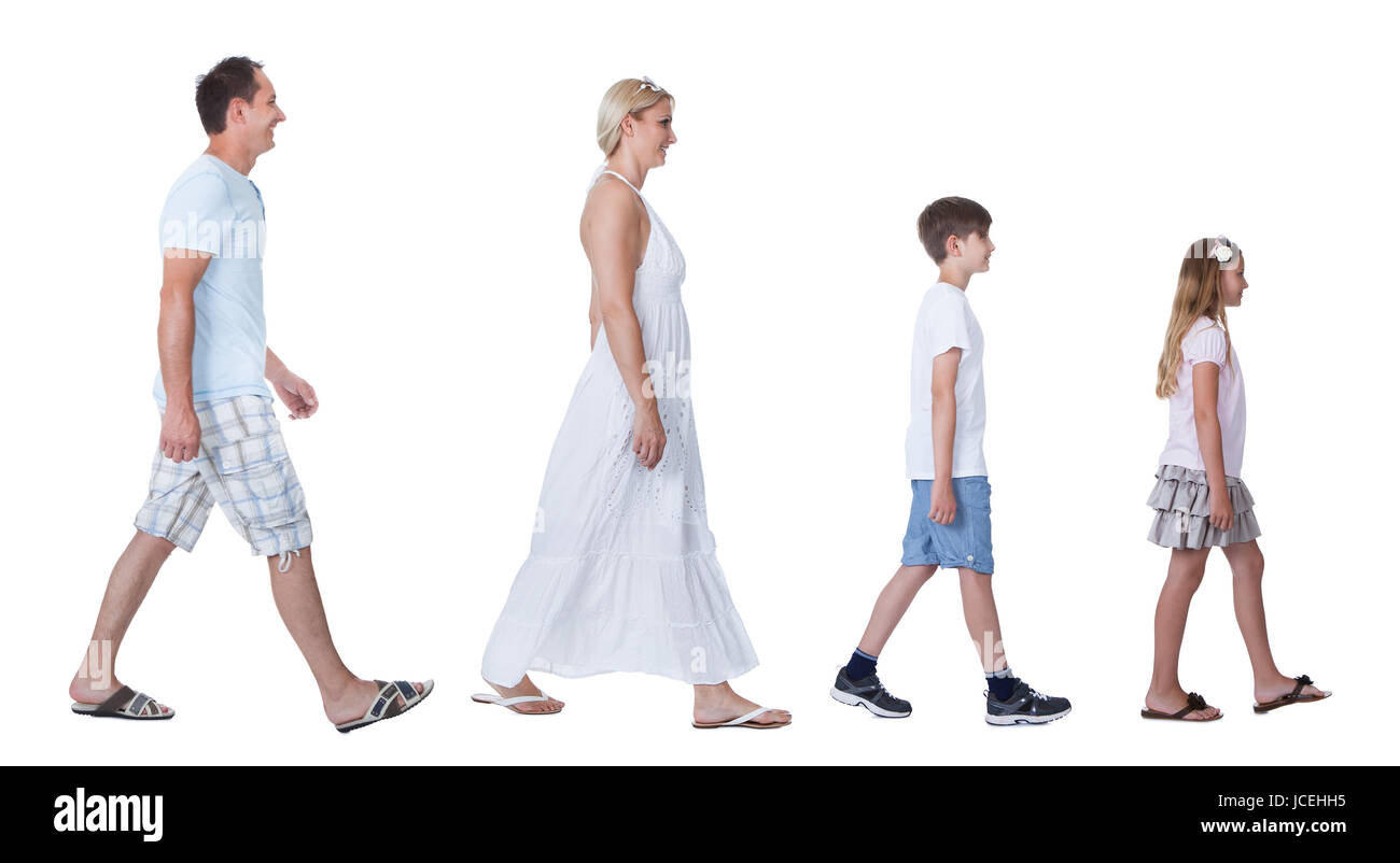 A Happy Family With Two Children Walking In A Line Isolated On White ...