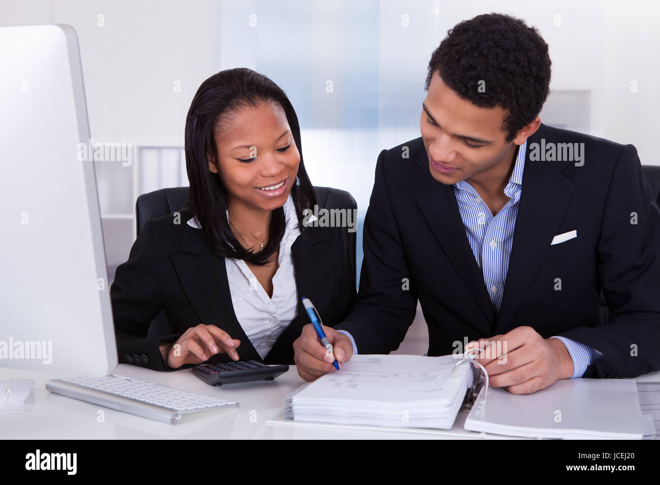 Two Business People Calculating Finance Together In Office Stock Photo ...