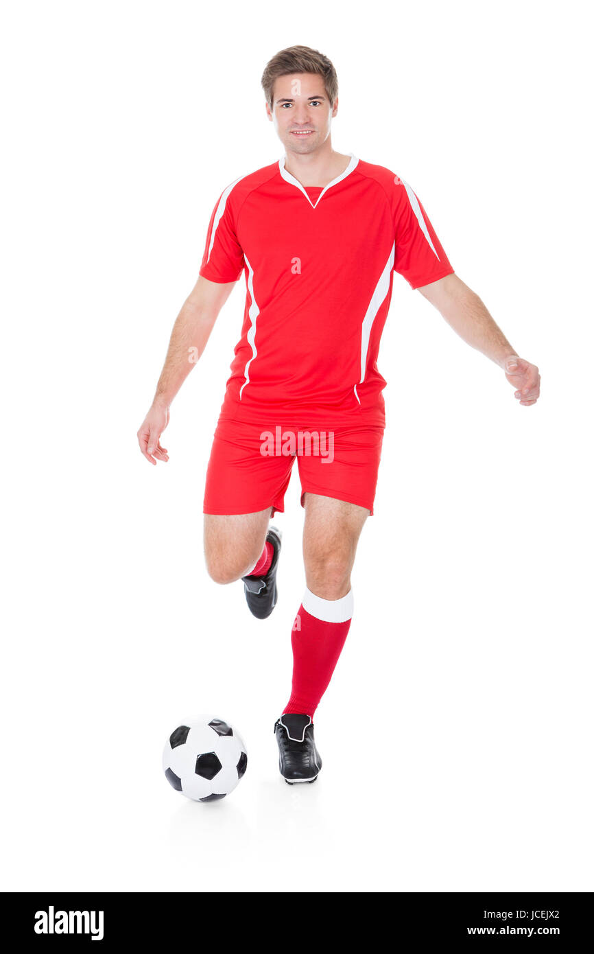 Soccer Player Kicking Football On White Background Stock Photo - Alamy