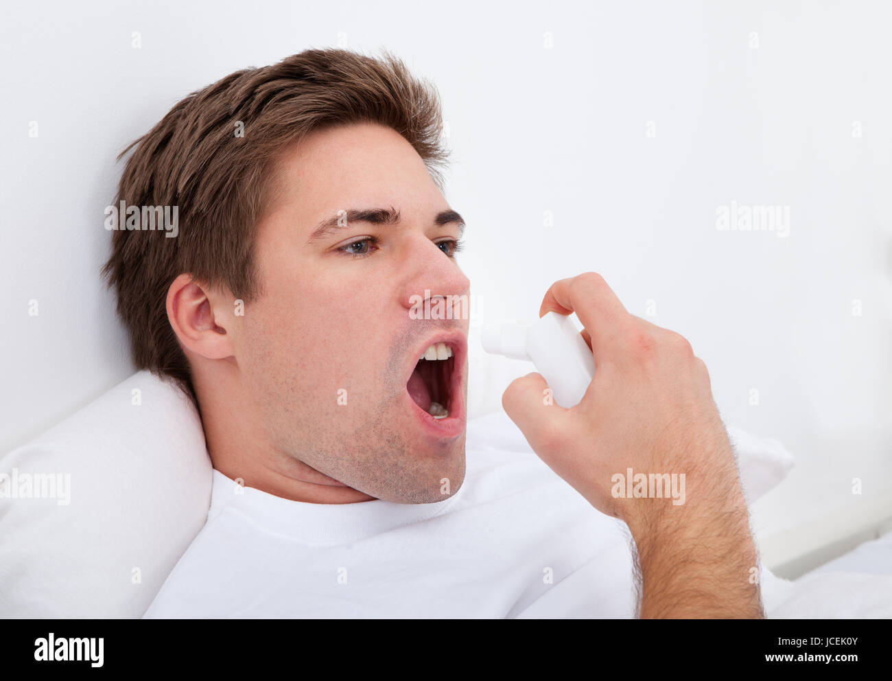 Man Using Asthma Inhaler For Preventing Attacks Stock Photo - Alamy