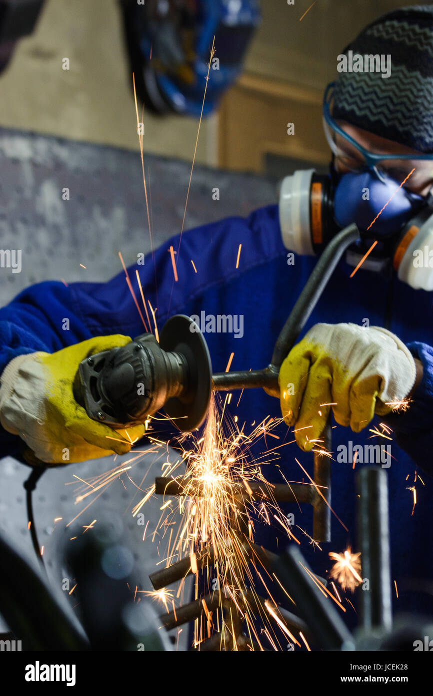 Metal grinding on steel pipe with flash of sparks close up Stock Photo ...