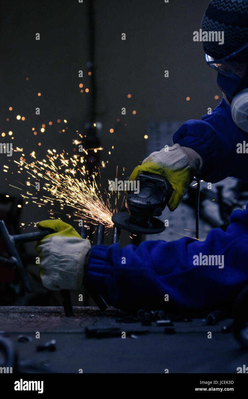 Metal grinding on steel pipe with flash of sparks close up Stock Photo ...