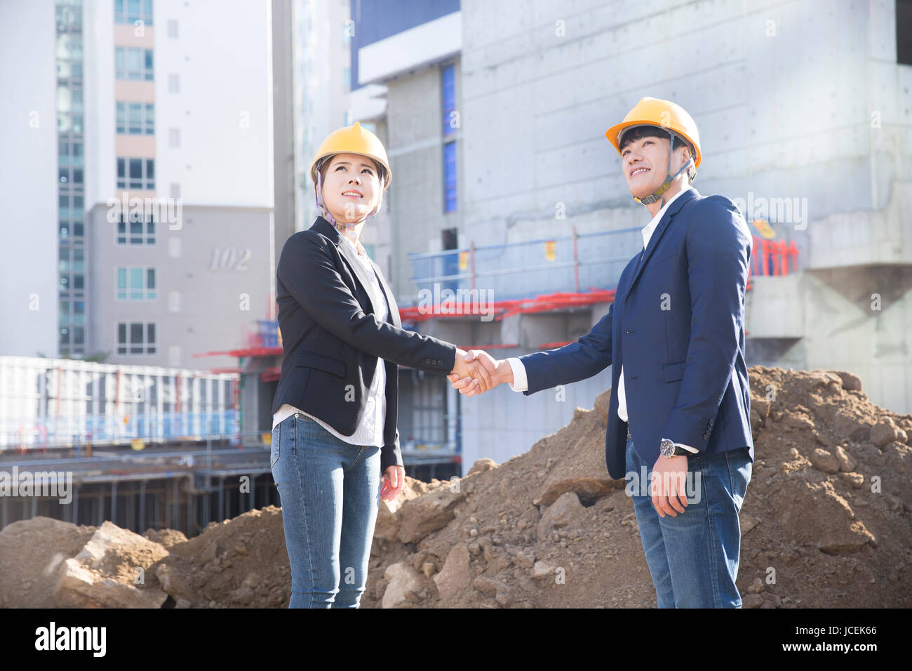 Two architects shaking hands with each other at construction site Stock ...