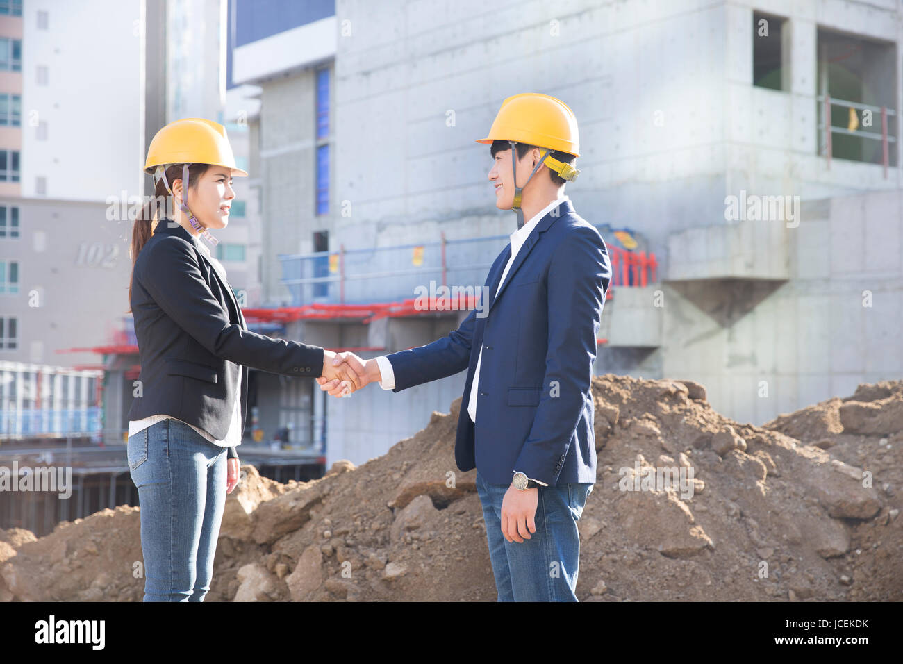 Two architects making a handshake at construction site Stock Photo - Alamy