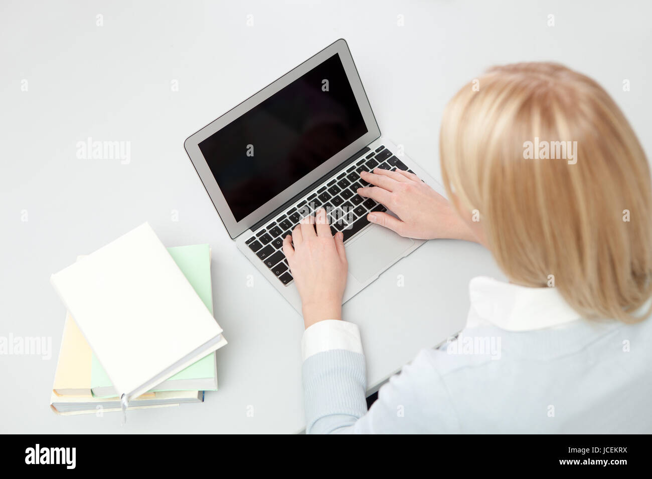 Beautiful student girl studying with laptop at the desk. Isolated on ...