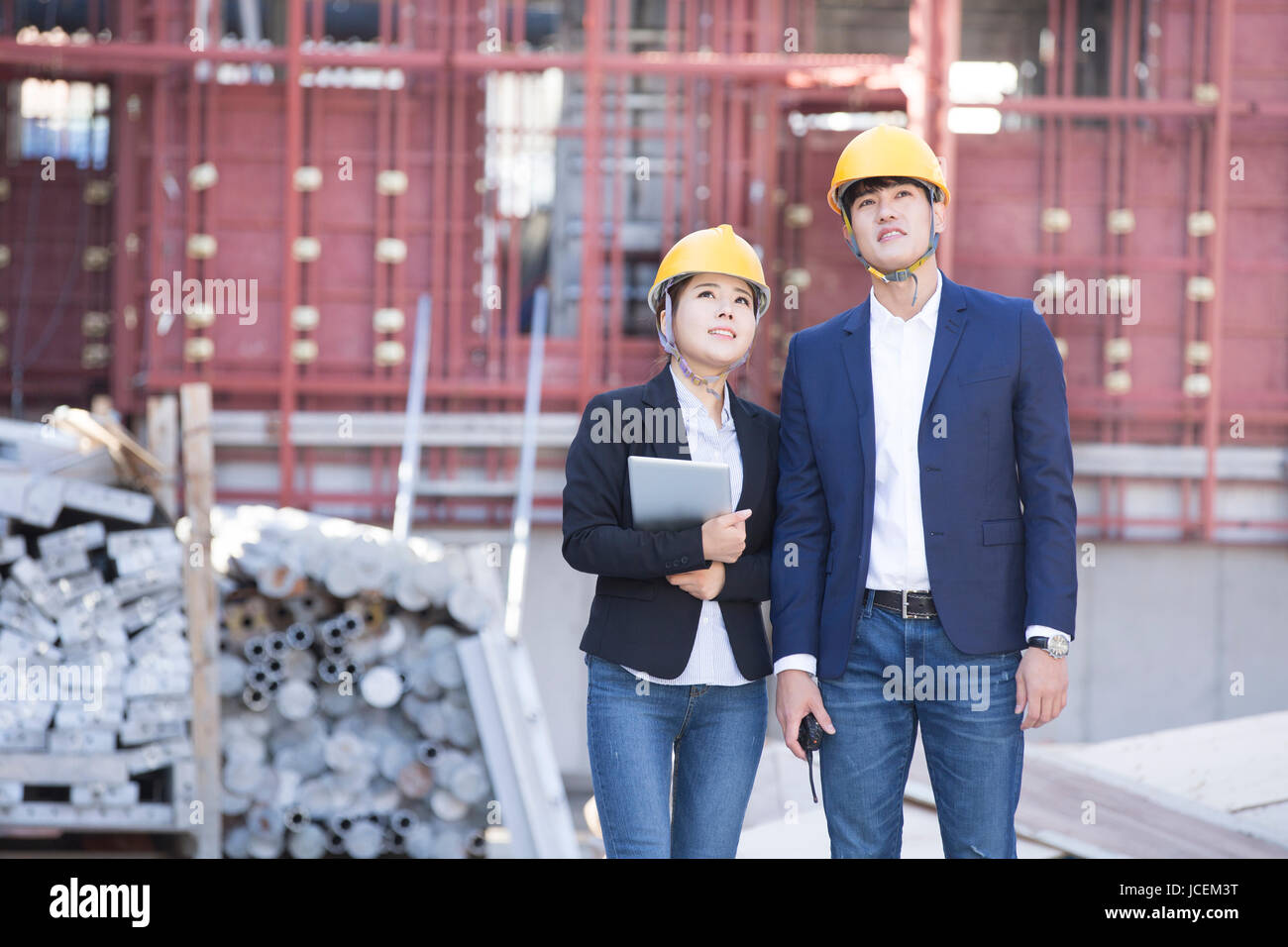 Two architects looking up at construction site Stock Photo - Alamy