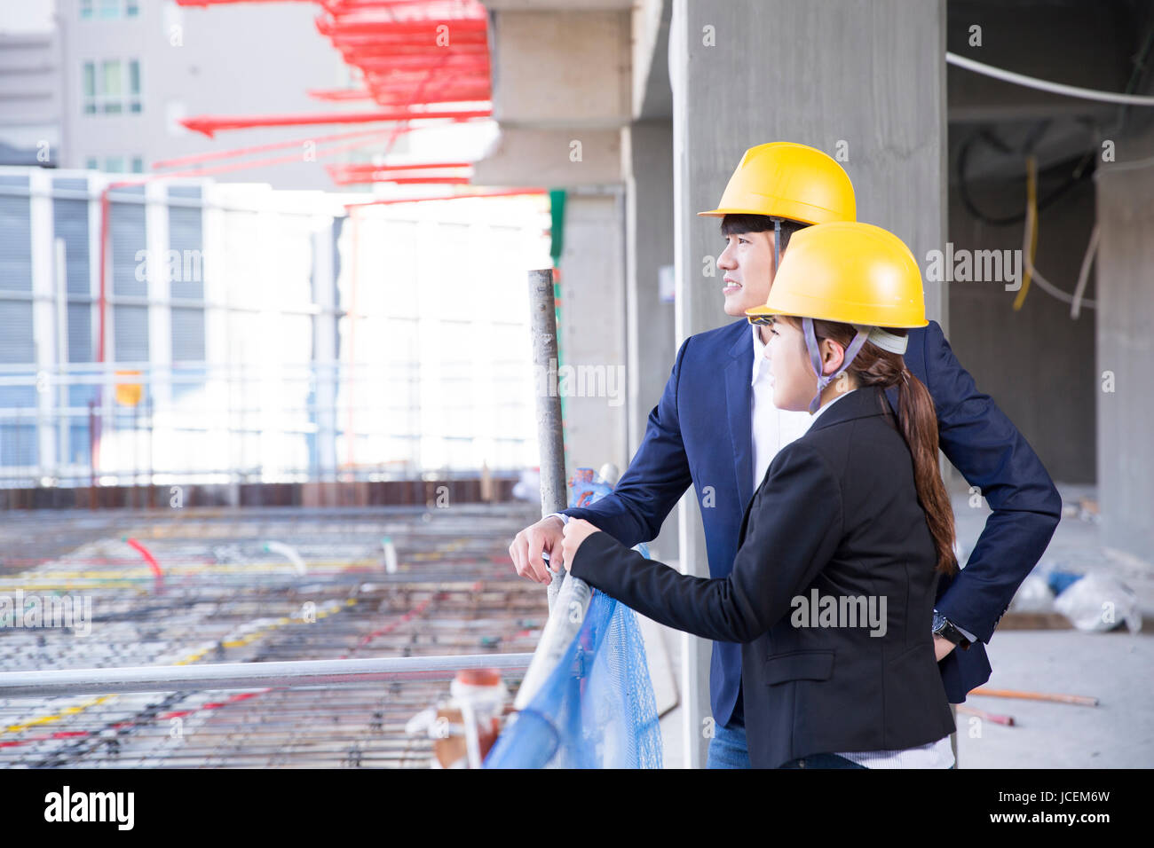 Side view of two architects at construction site Stock Photo - Alamy