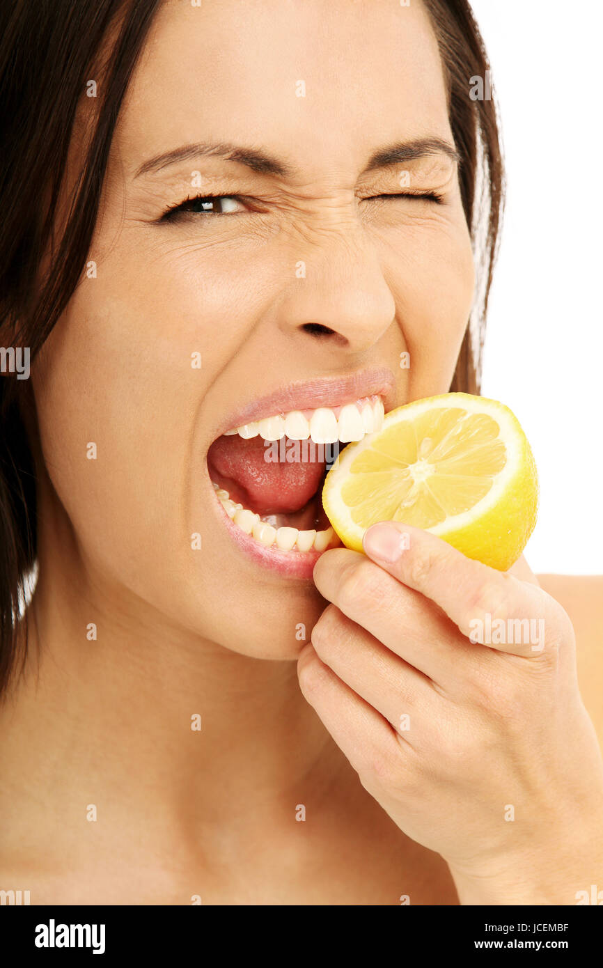 woman biting into lemon Stock Photo - Alamy