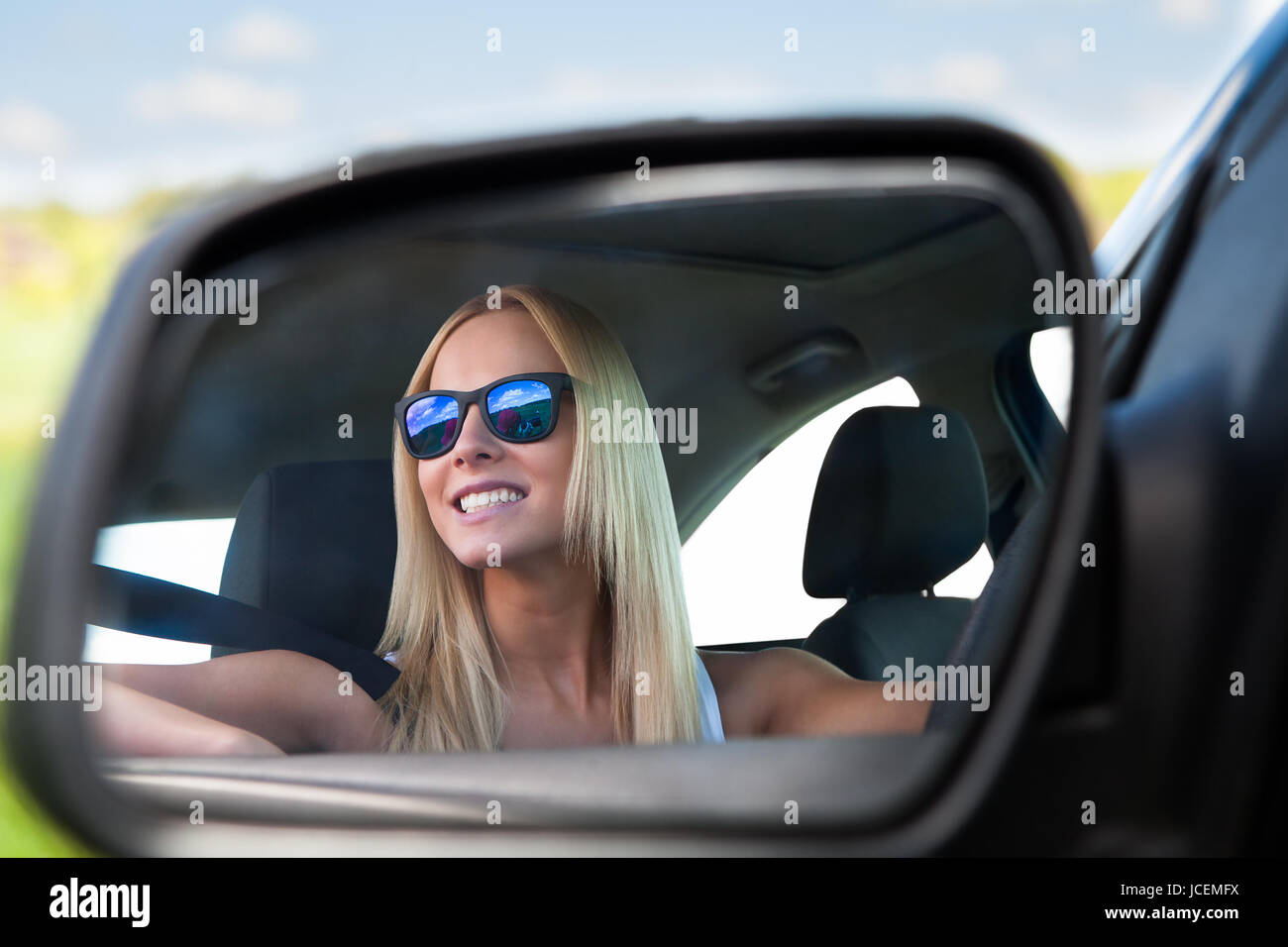 Young Blonde Woman Wearing Sunglasses Driving Car Stock Photo - Alamy