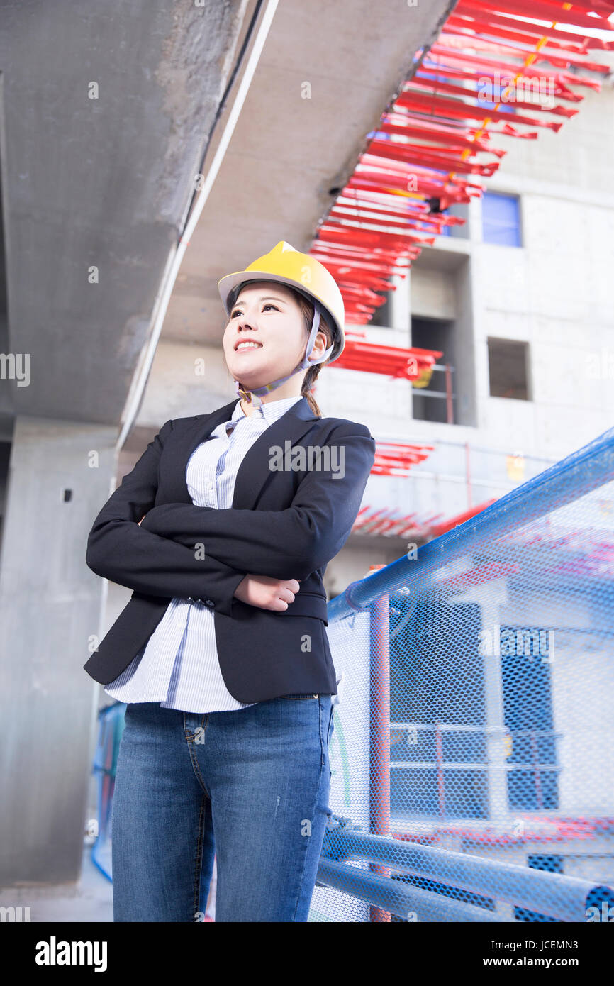 Smiling female architect at construction site Stock Photo - Alamy