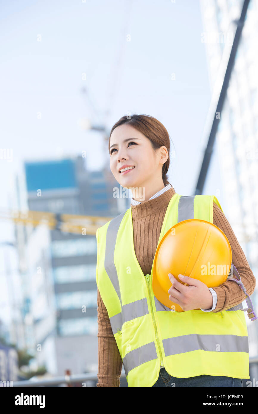 Smiling female construction worker Stock Photo - Alamy