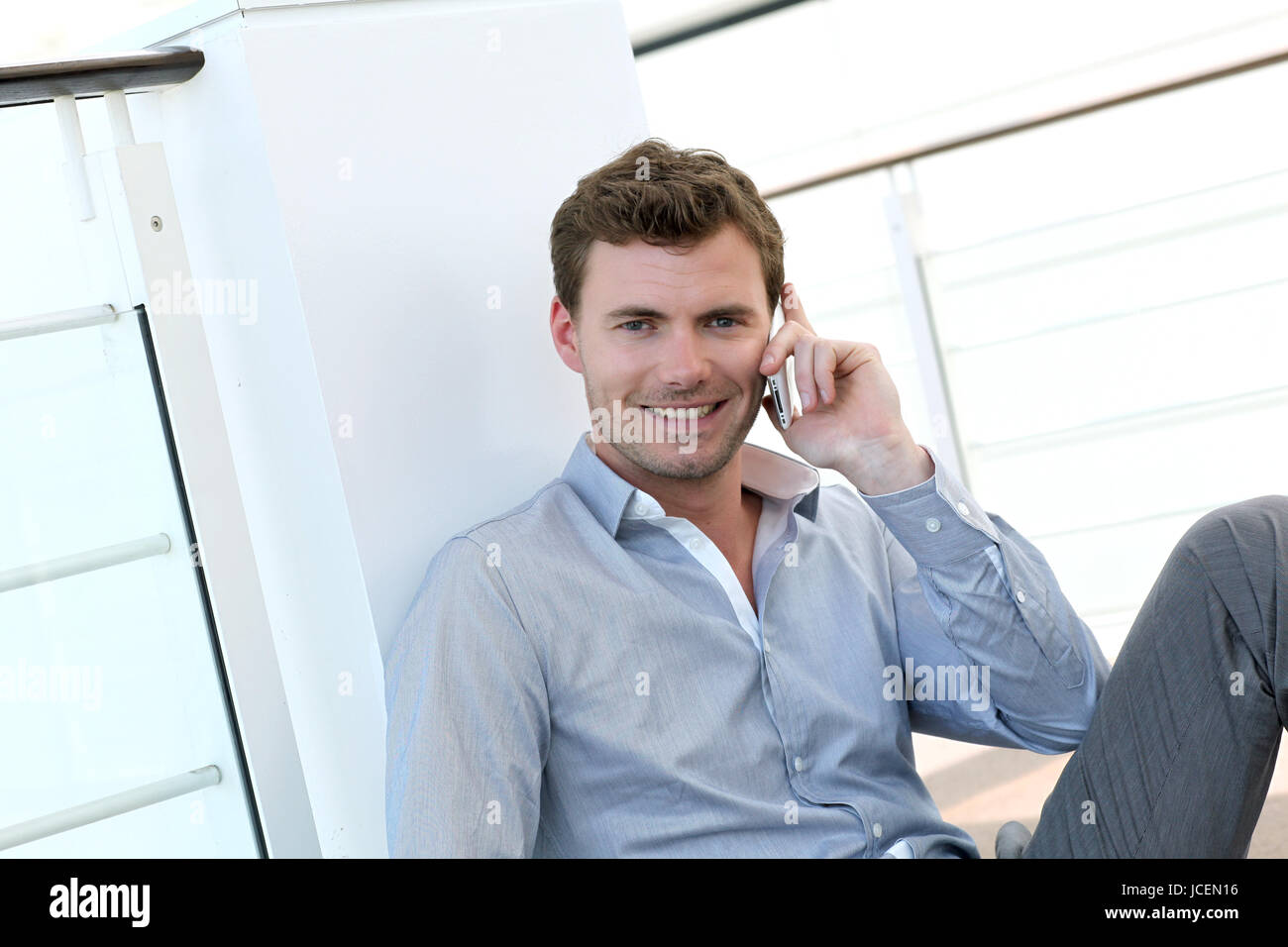 Handsome man having phonecall at work Stock Photo - Alamy