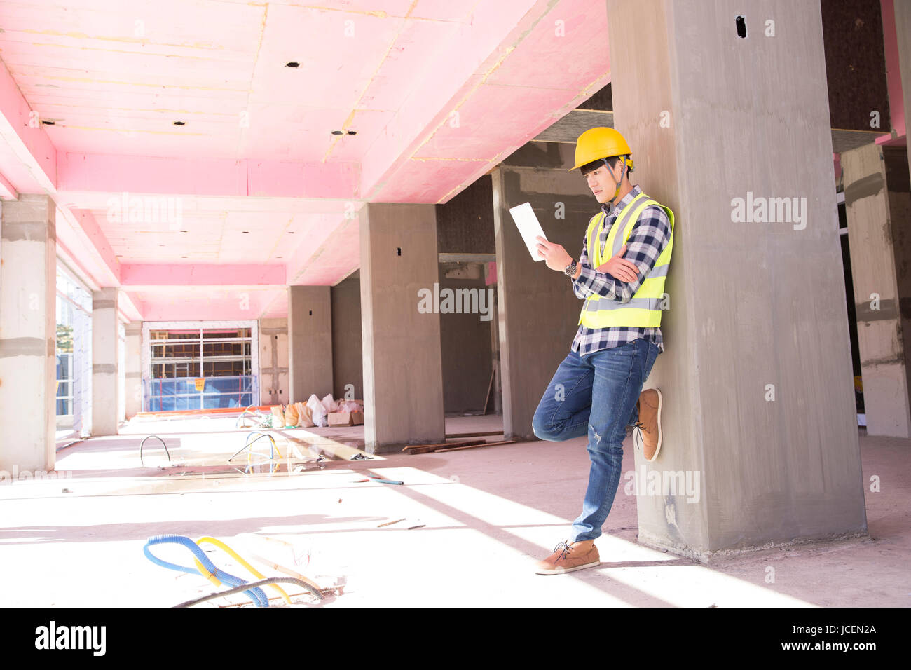 Construction worker with tablet standing Stock Photo - Alamy