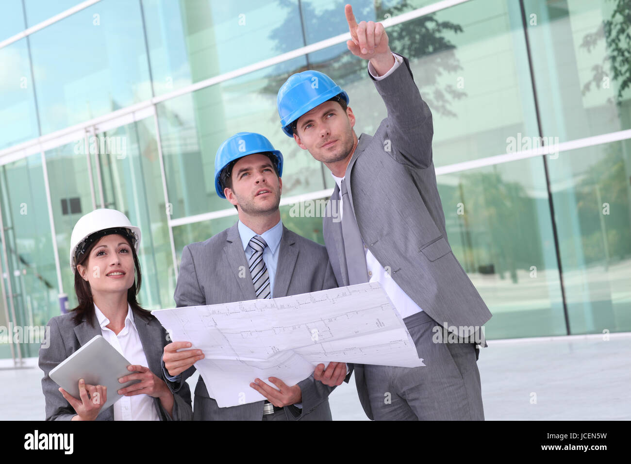 Construction workers checking drawing hi-res stock photography and ...