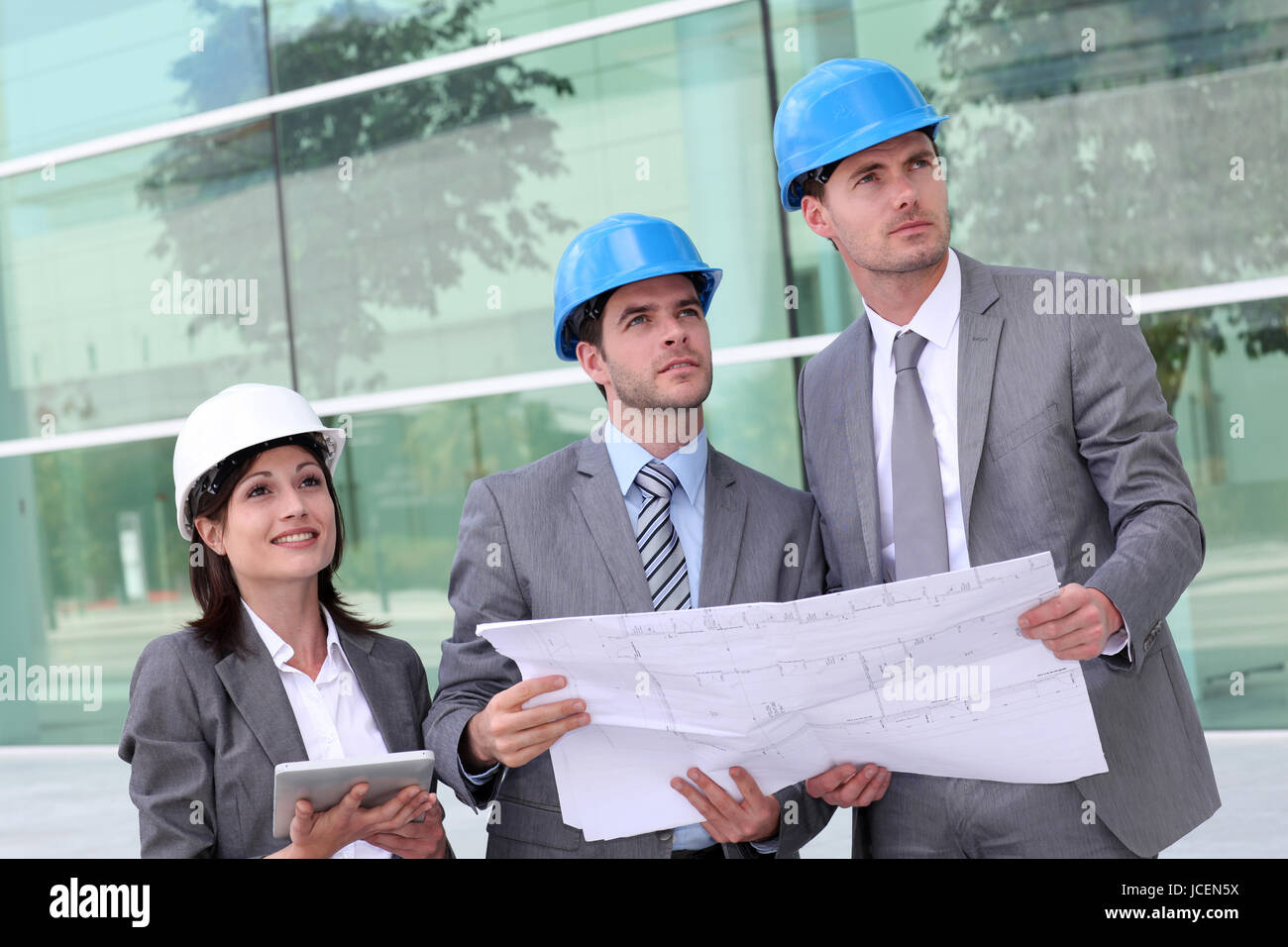 Business people checking construction site Stock Photo - Alamy