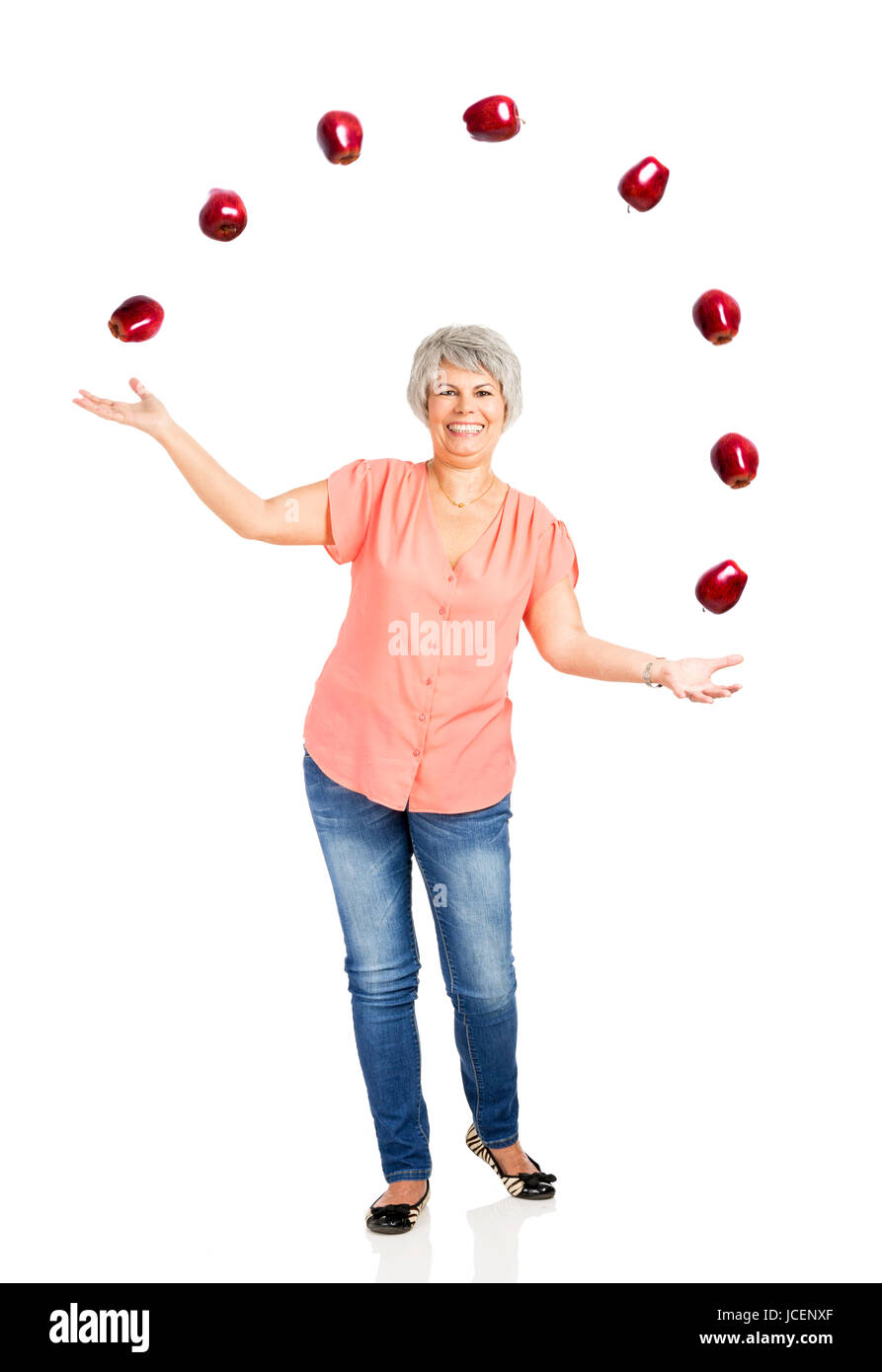 Old woman throwing apples, isoalted over white background Stock Photo ...