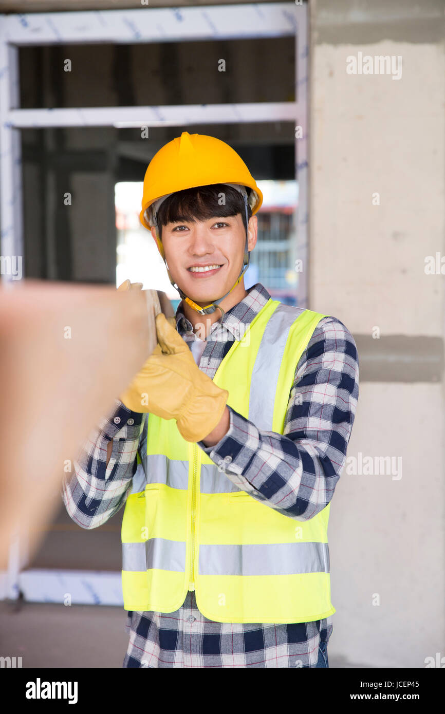 Smiling construction worker Stock Photo - Alamy
