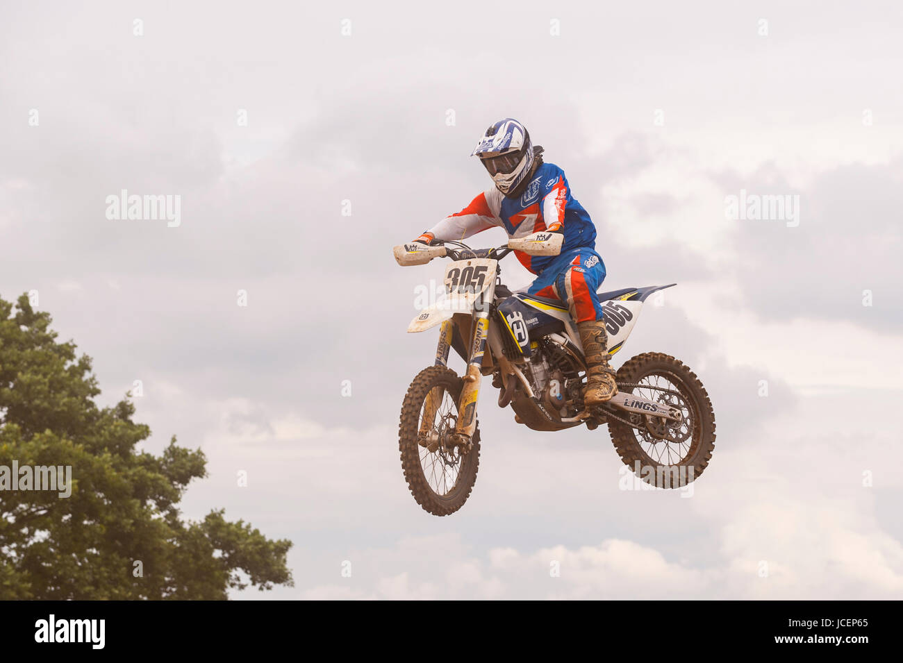 Motocross bike scrambler jumping on a uk track Stock Photo - Alamy