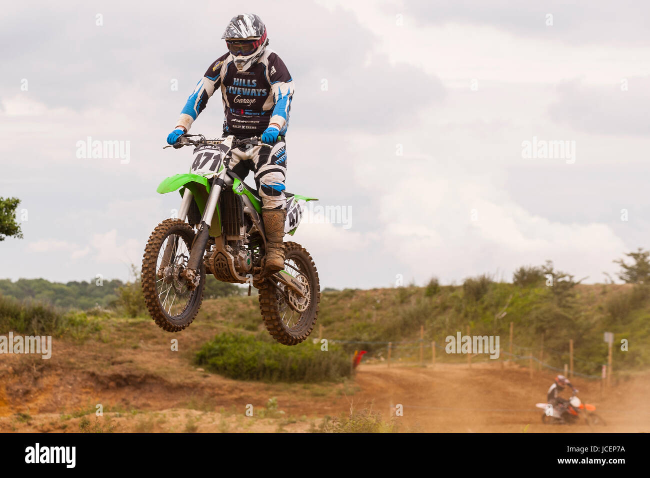 Motocross bike scrambler jumping on a uk track Stock Photo - Alamy