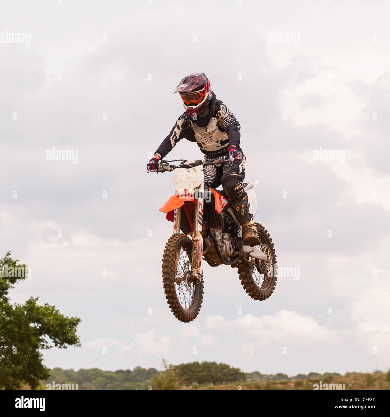 Motocross bike scrambler jumping on a uk track Stock Photo - Alamy