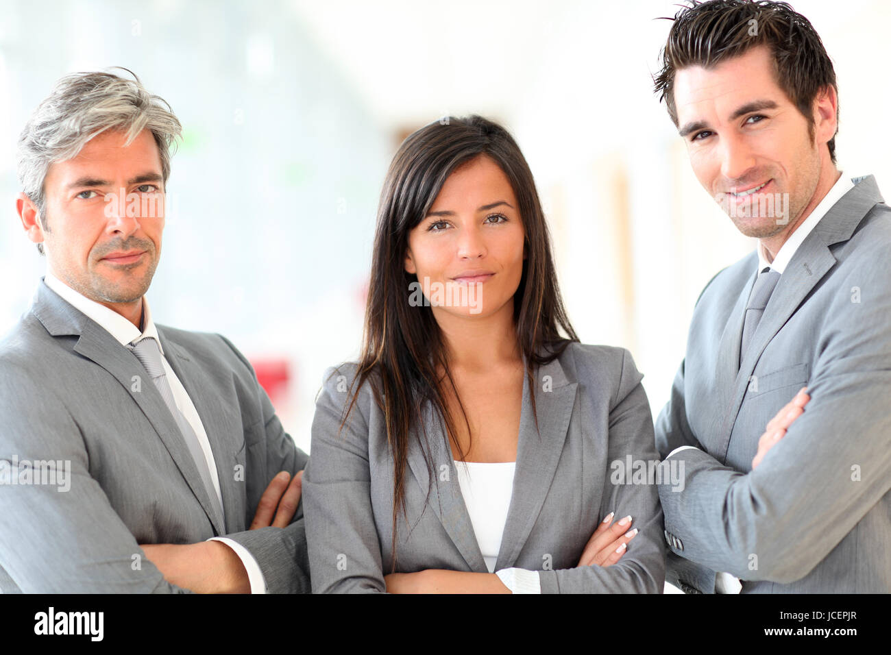 Business team standing in hall Stock Photo - Alamy
