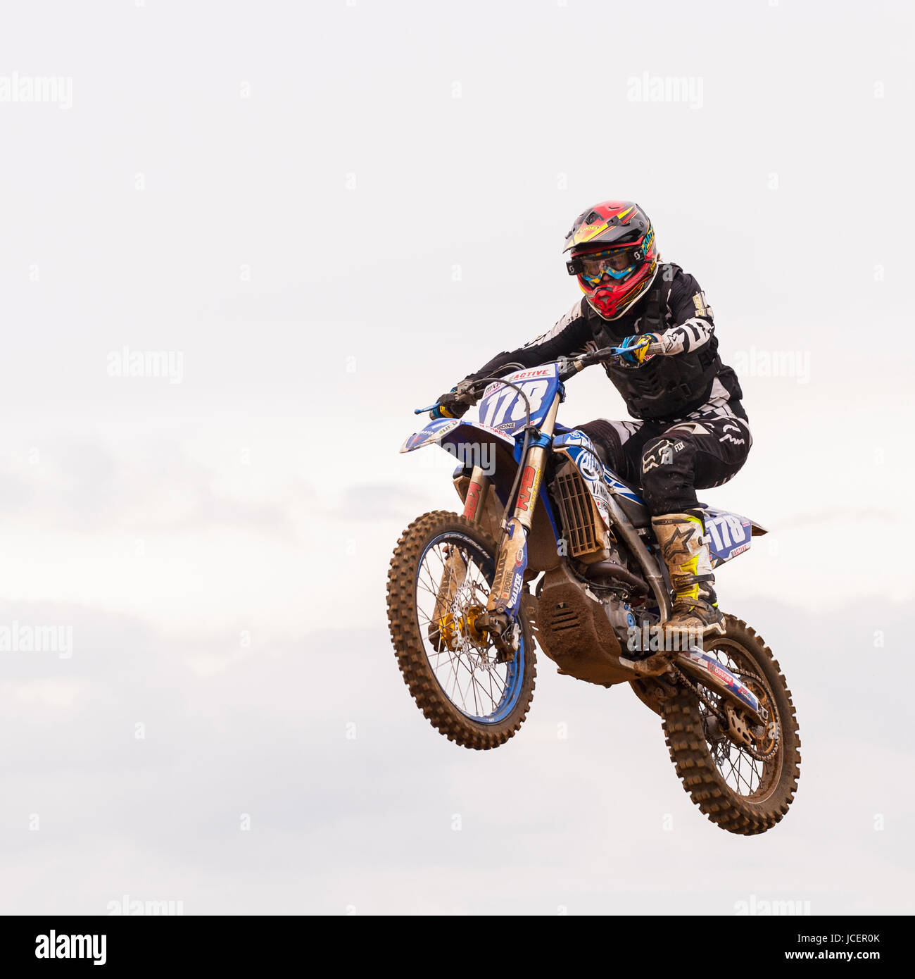 Motocross bike scrambler jumping on a uk track Stock Photo - Alamy