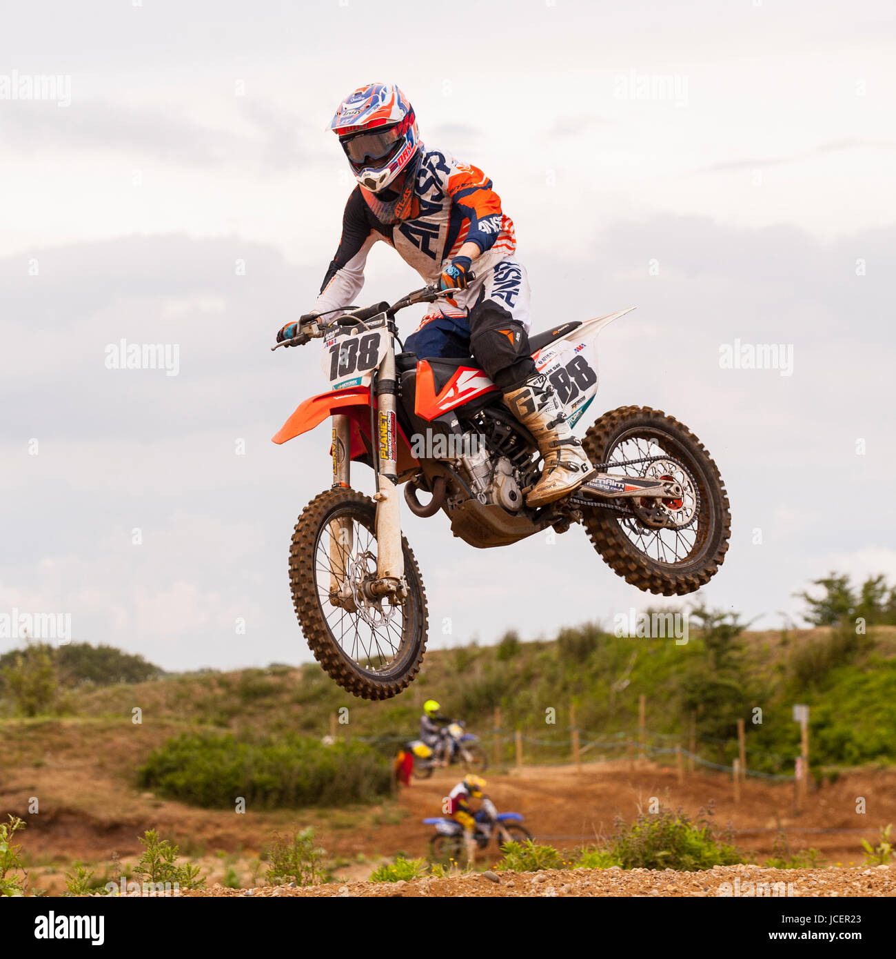 Motocross bike scrambler jumping on a uk track Stock Photo - Alamy