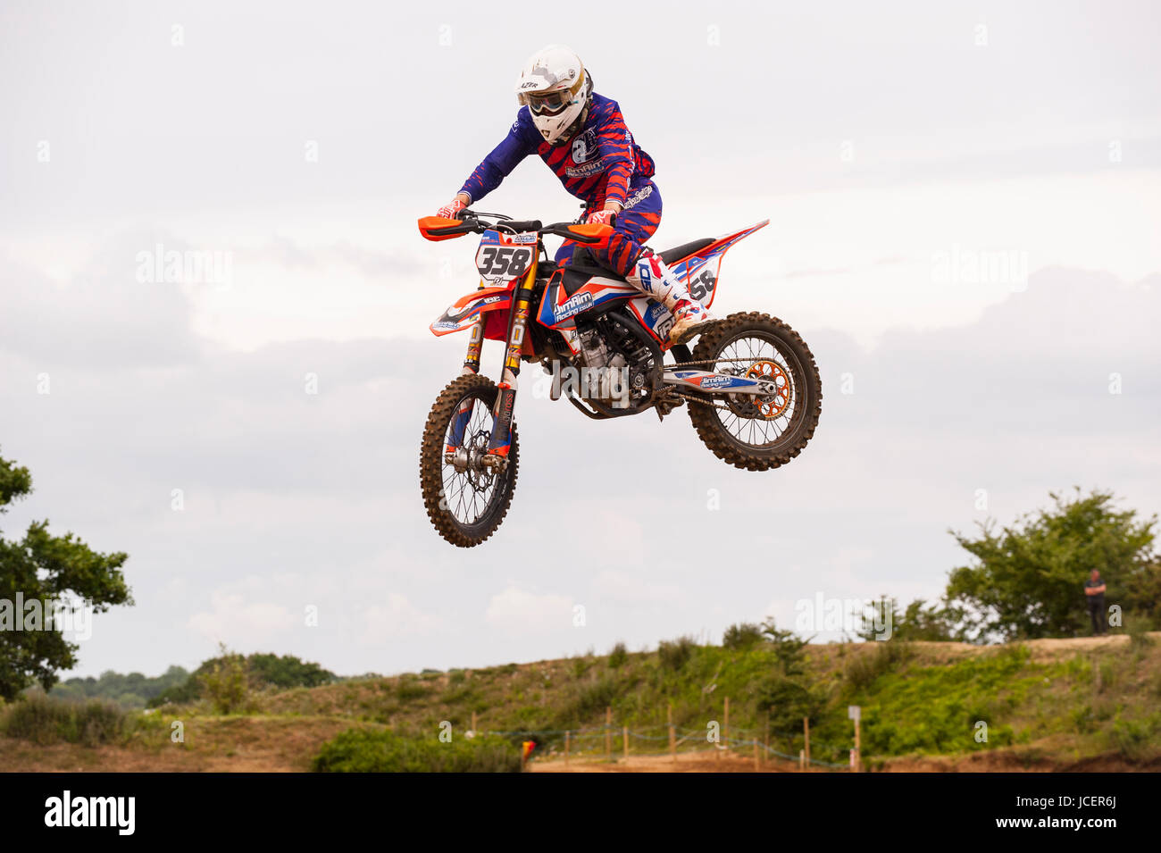 Motocross bike scrambler jumping on a uk track Stock Photo - Alamy