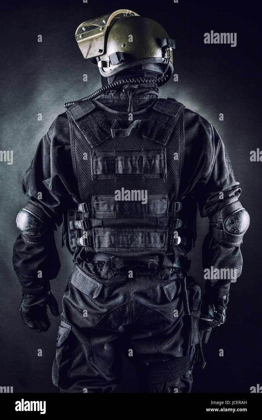 Spec ops soldier on black background shot from behind Stock Photo - Alamy
