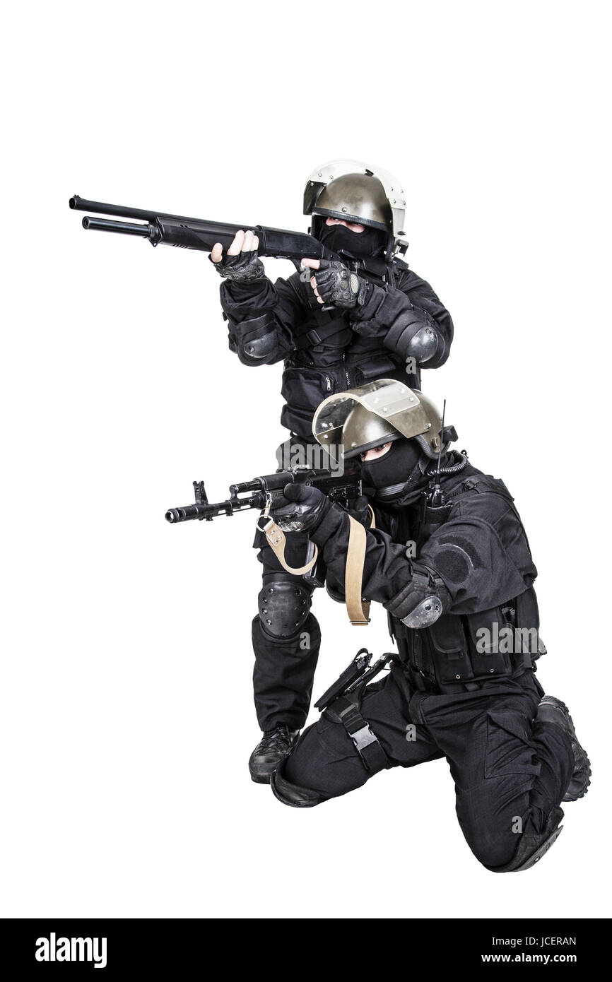 Two spec ops soldiers in black uniform in action Stock Photo - Alamy