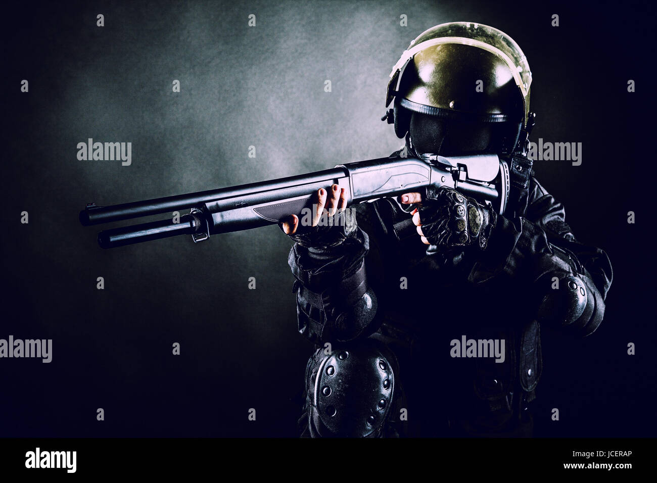 Spec ops soldier on black background with shotgun Stock Photo - Alamy