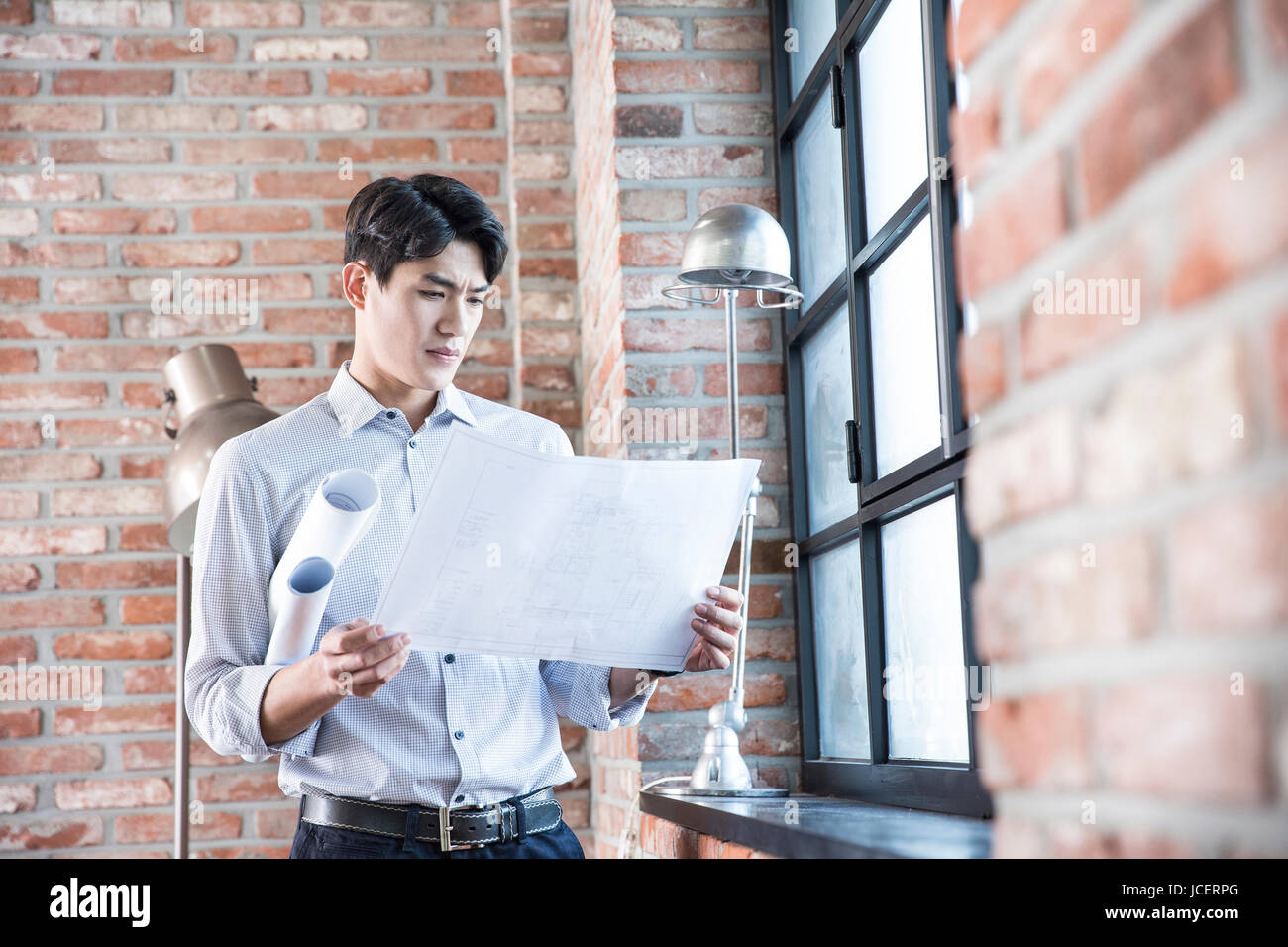Male architect with papers at office Stock Photo - Alamy