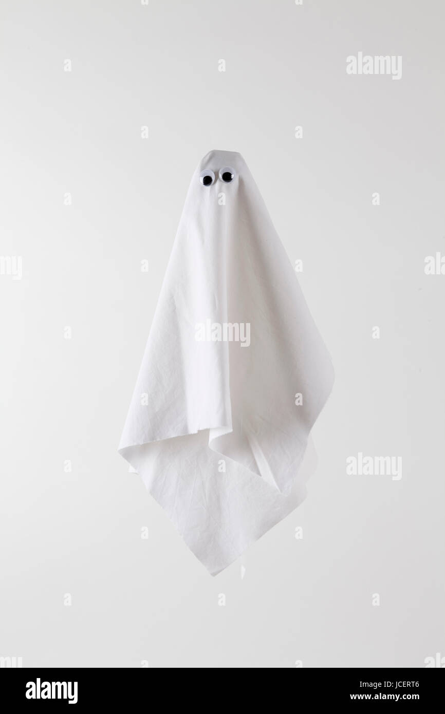 white sheet ghost isolated on a white background. Tones on tones ...