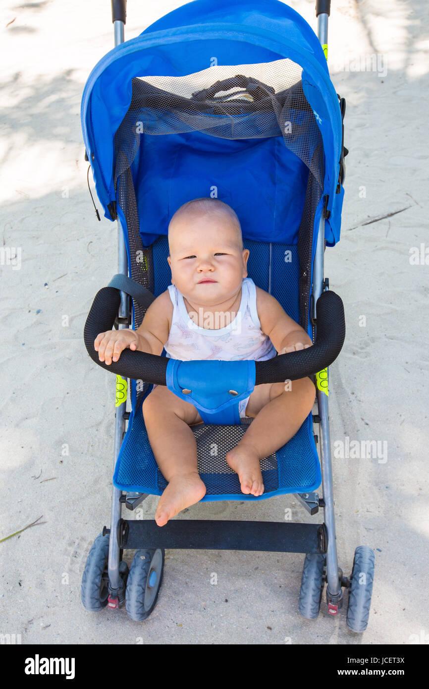 Adorable baby sitting in stroller Stock Photo - Alamy