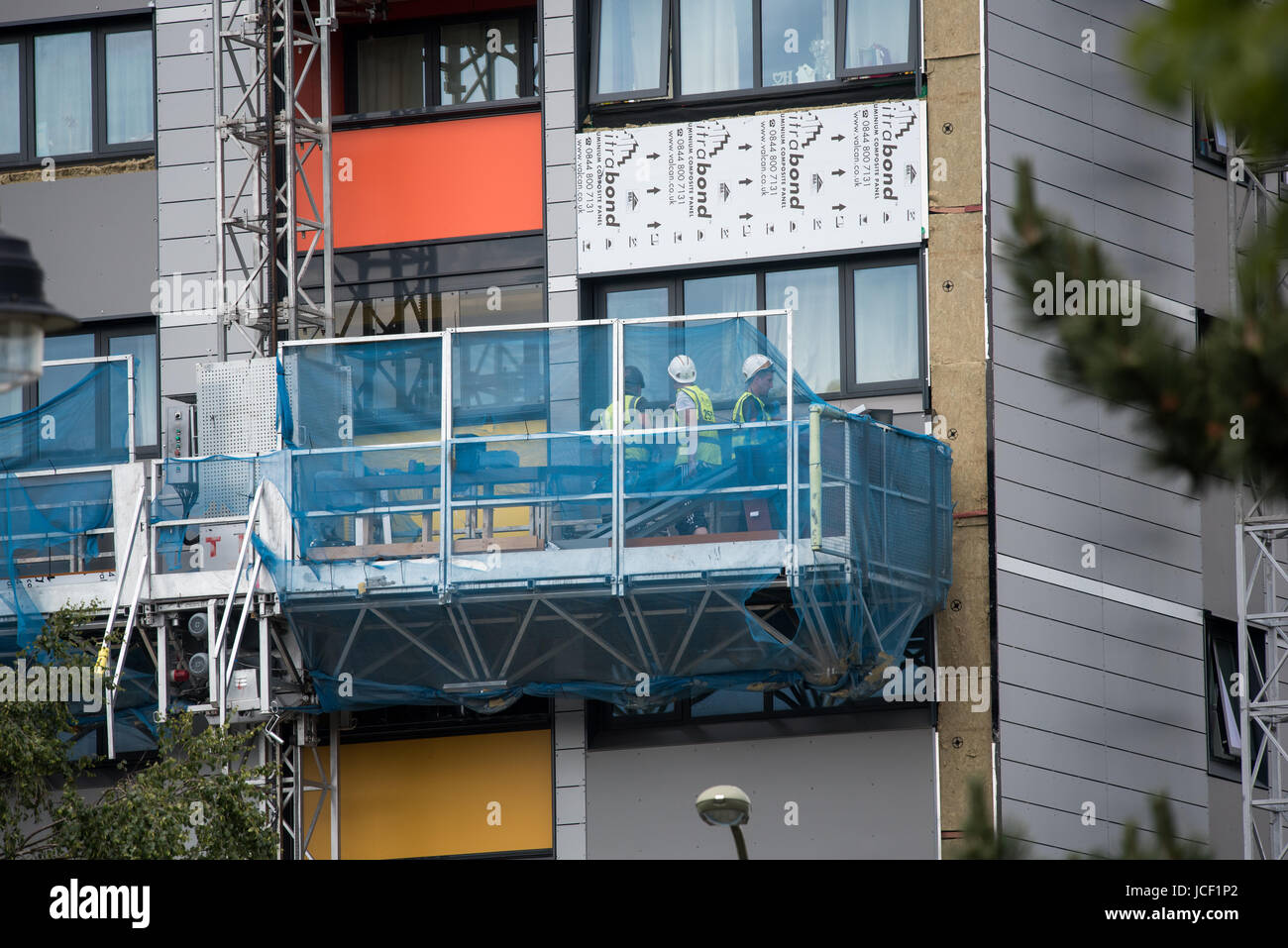 Dangerous flammable cladding panels being removed from on a tower block ...
