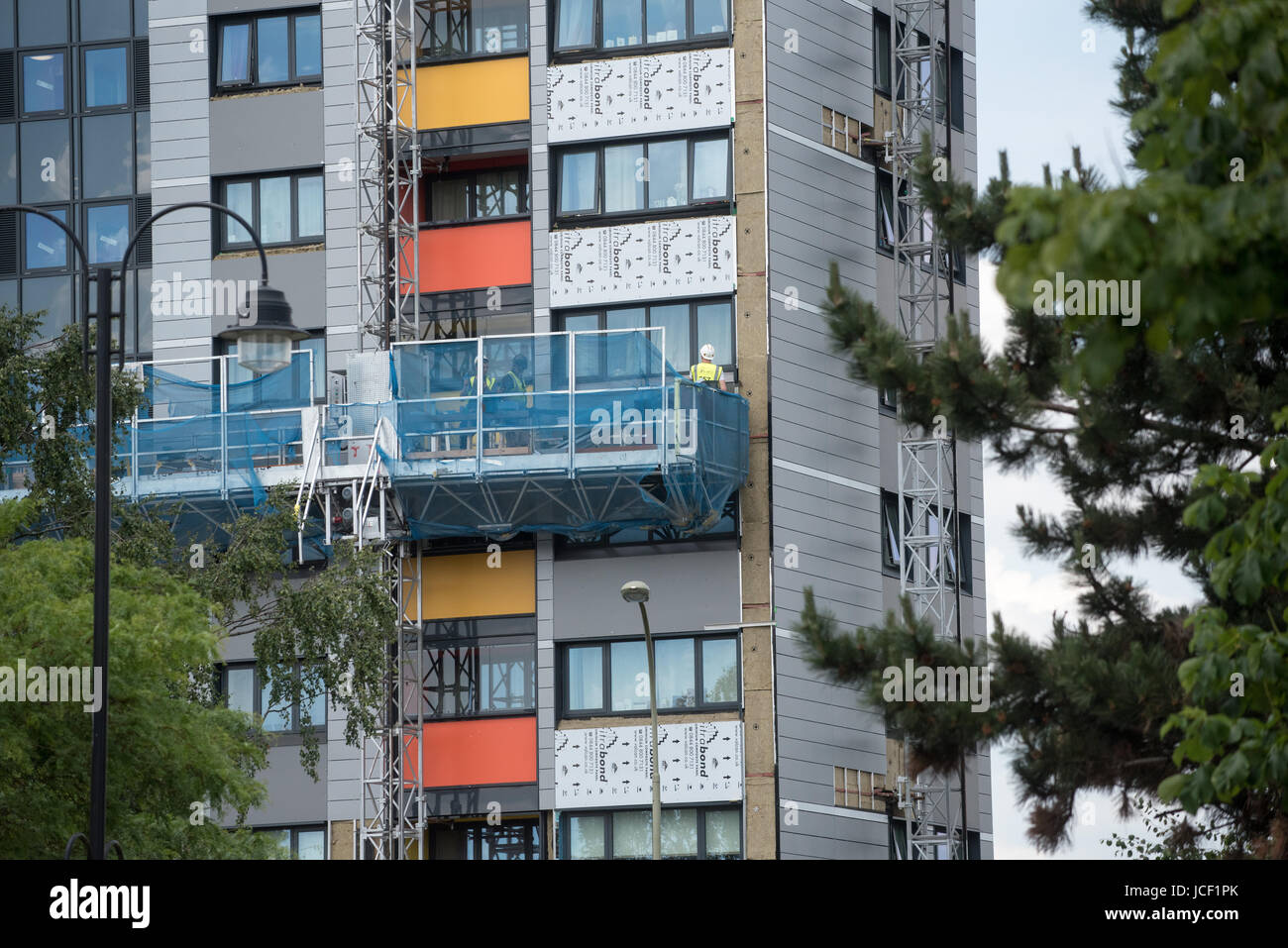 Dangerous flammable cladding panels being removed from on a tower block ...