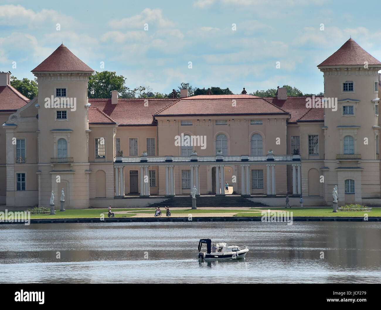 A boat on Grienericksee lake in sunny weather in front of Rheinsberg ...