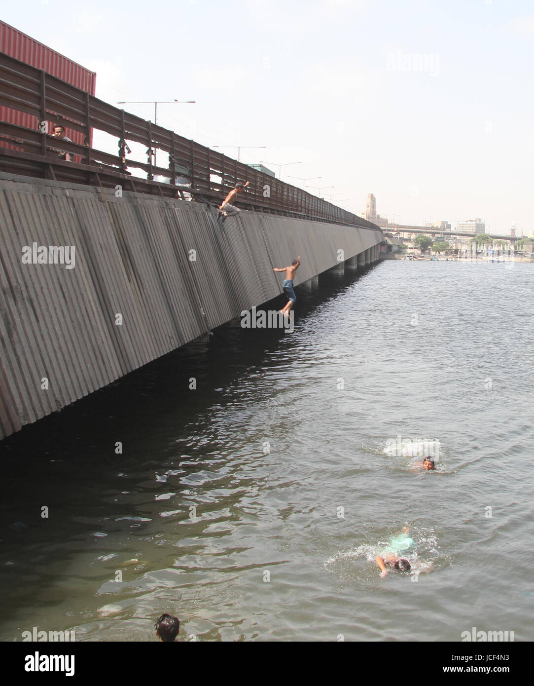 Children diving into sea water to beat the heat of scorching sun at ...