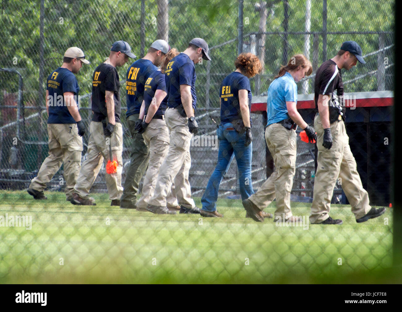 Evidence technicians from the FBI comb through the crime scene for ...