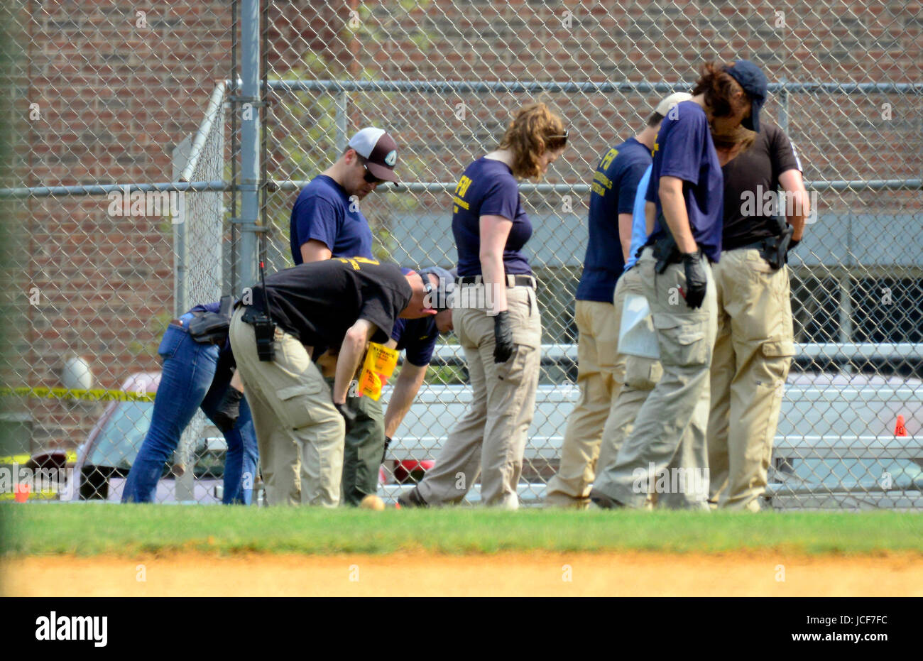 Evidence technicians from the FBI comb through the crime scene for ...