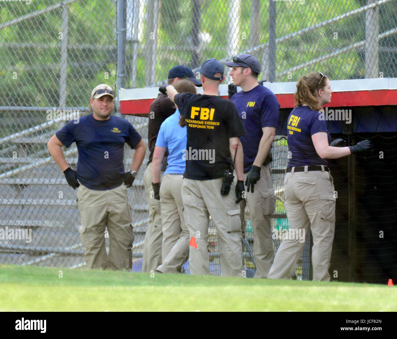 Evidence technicians from the FBI comb through the crime scene for ...