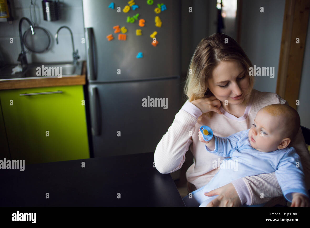 Young mother with baby, indoor, happy family Stock Photo - Alamy
