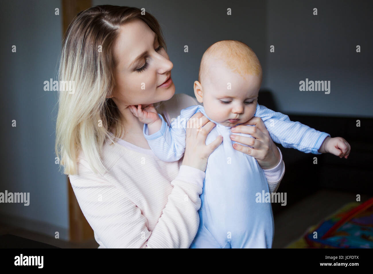 Young mother with baby, indoor, happy family Stock Photo - Alamy