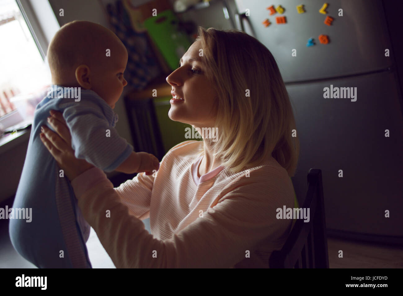 Young mother with baby, indoor, happy family Stock Photo - Alamy