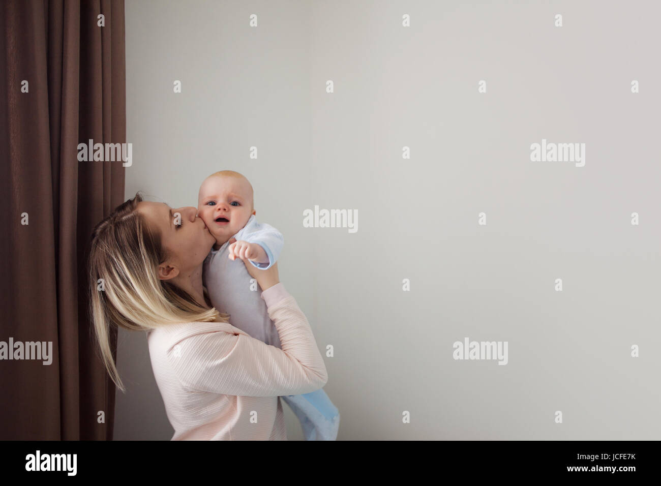 Young mother with baby, indoor, happy family Stock Photo - Alamy