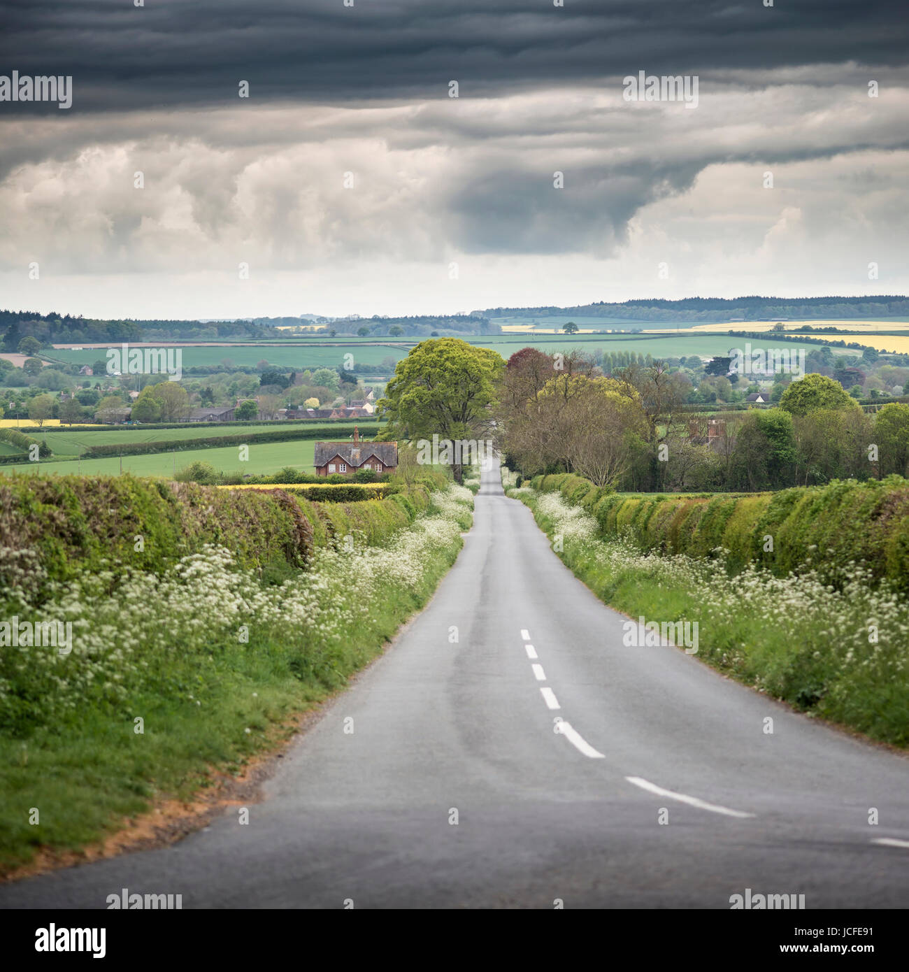 Landscape image of empty road in English countryside with stormy sky ...