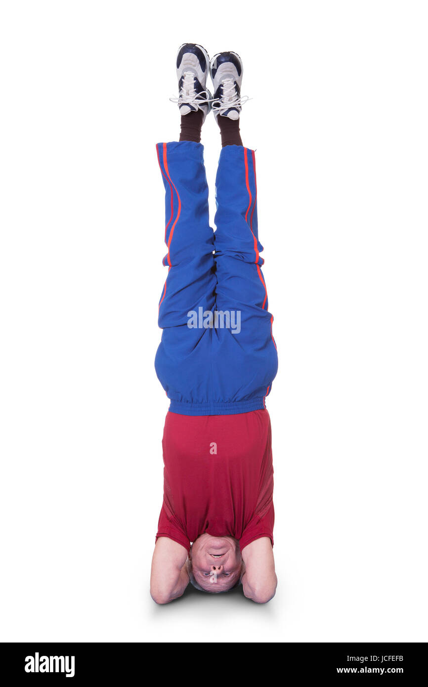 Senior Man Performing Yoga Headstand On White Background Stock Photo ...
