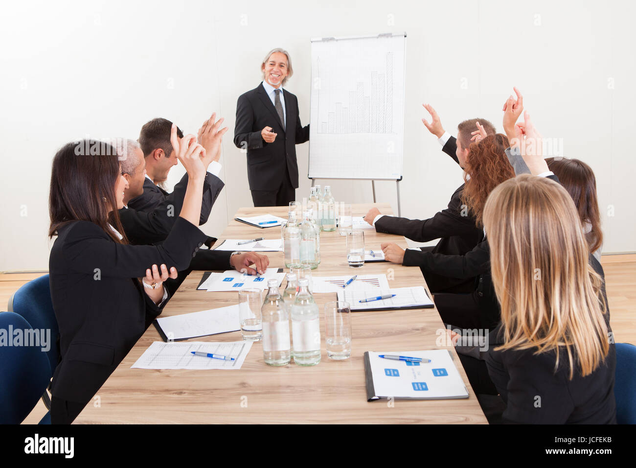 Businessman Raising His Hand Up At A Conference Stock Photo - Alamy